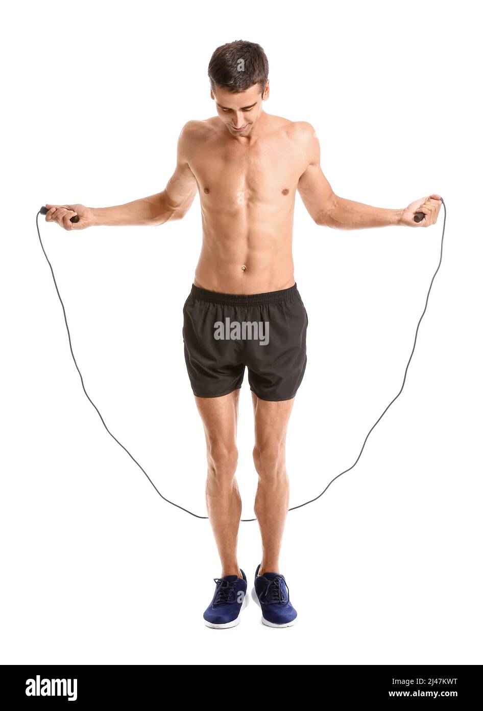 Sporty young man jumping rope on white background Stock Photo - Alamy