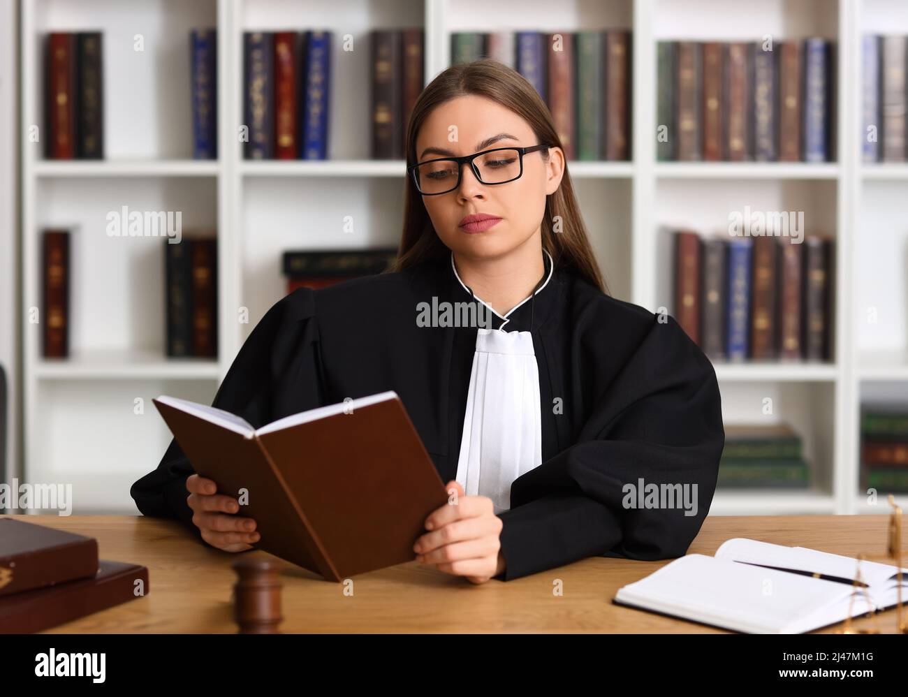 Female judge with book at workplace in courtroom Stock Photo - Alamy