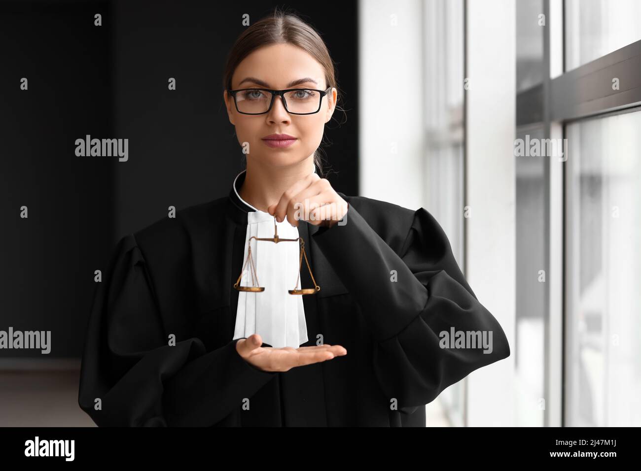 Female judge with scales of justice in courtroom Stock Photo - Alamy