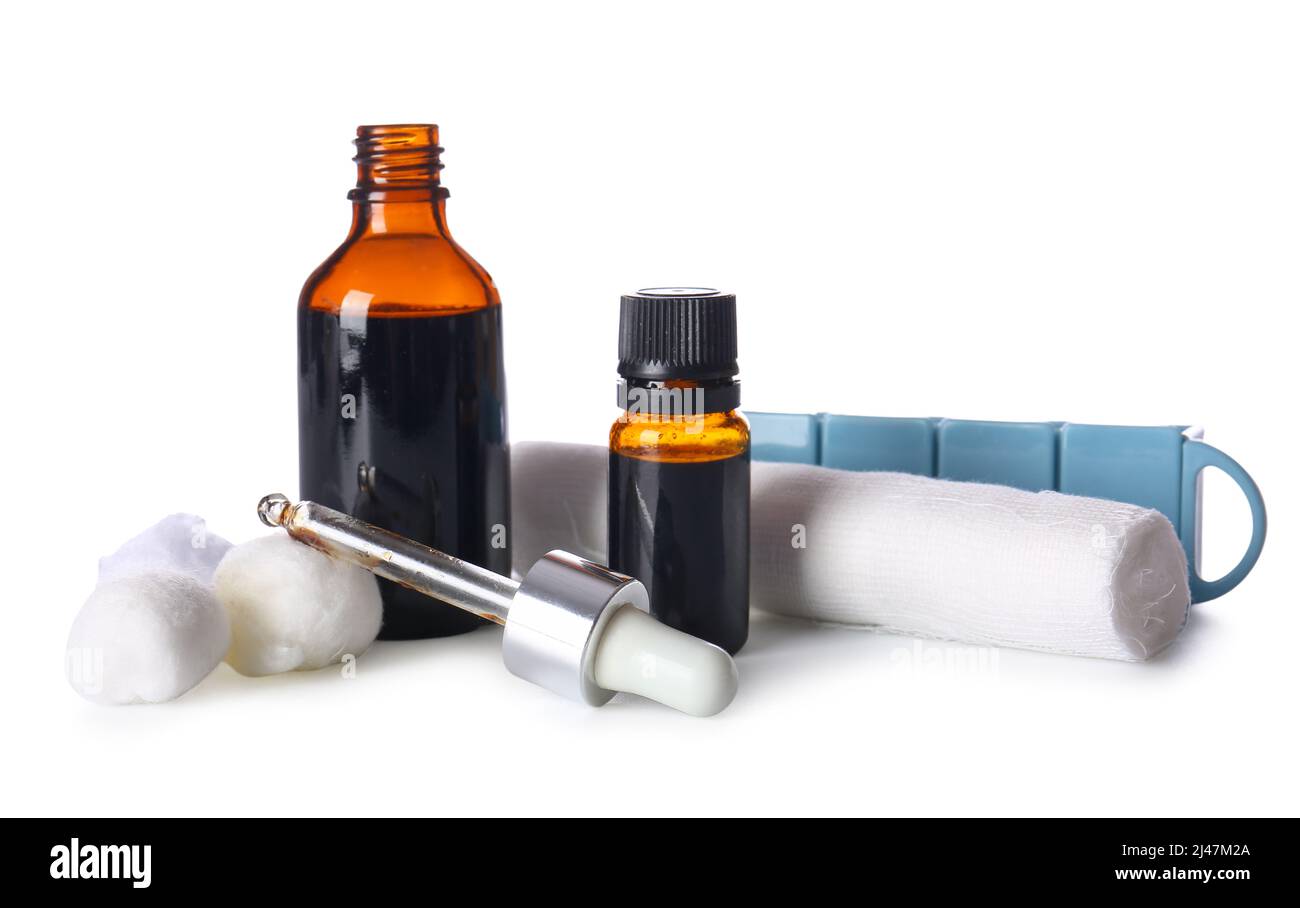 Bottles with iodine, cotton balls and medical bandage on white ...