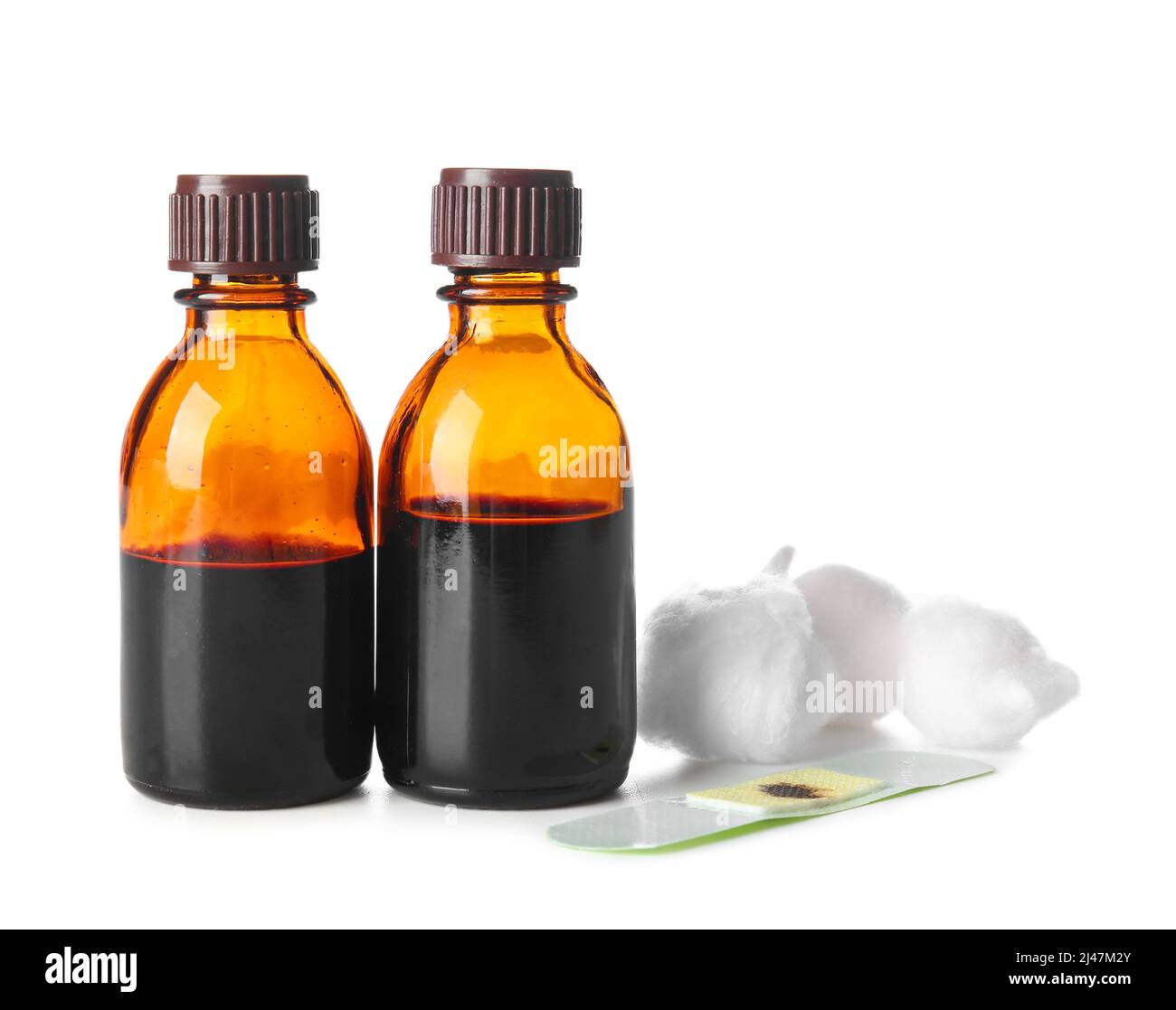 Bottles with iodine, medical plaster and cotton balls on white ...