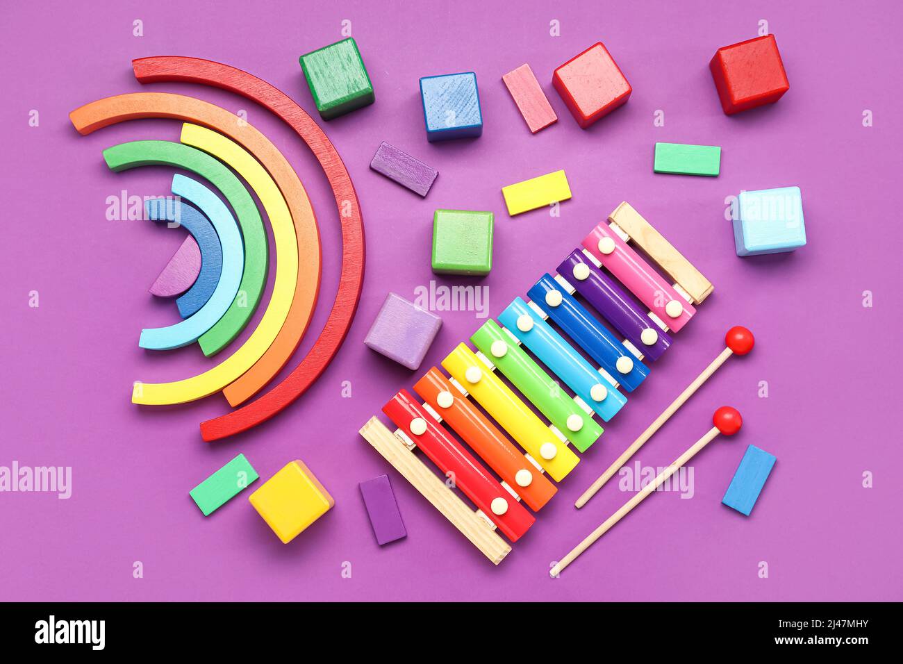 Wooden cubes with blocks and xylophone on purple background Stock Photo ...
