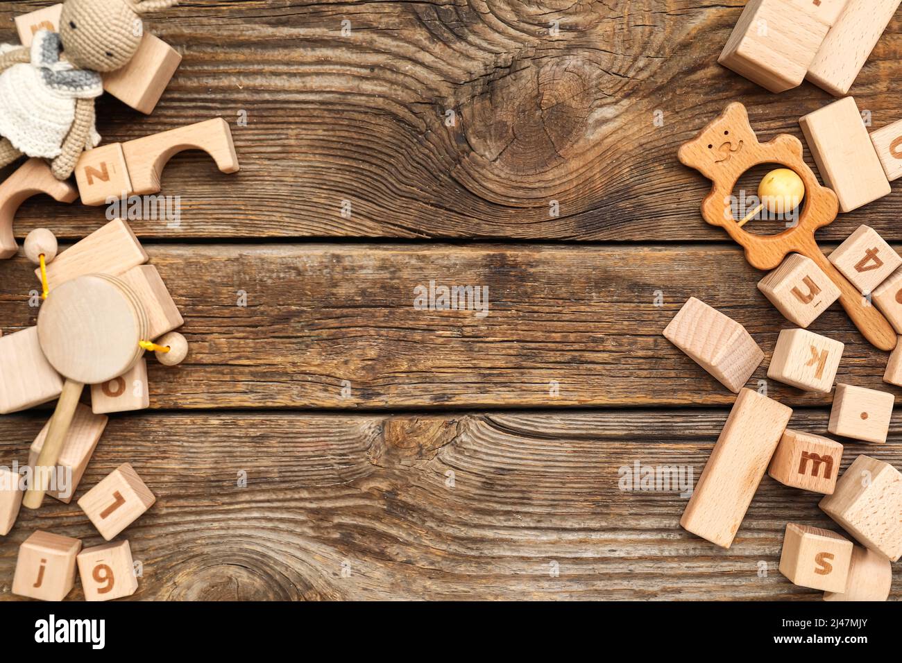 Frame made of baby toys on wooden background Stock Photo - Alamy