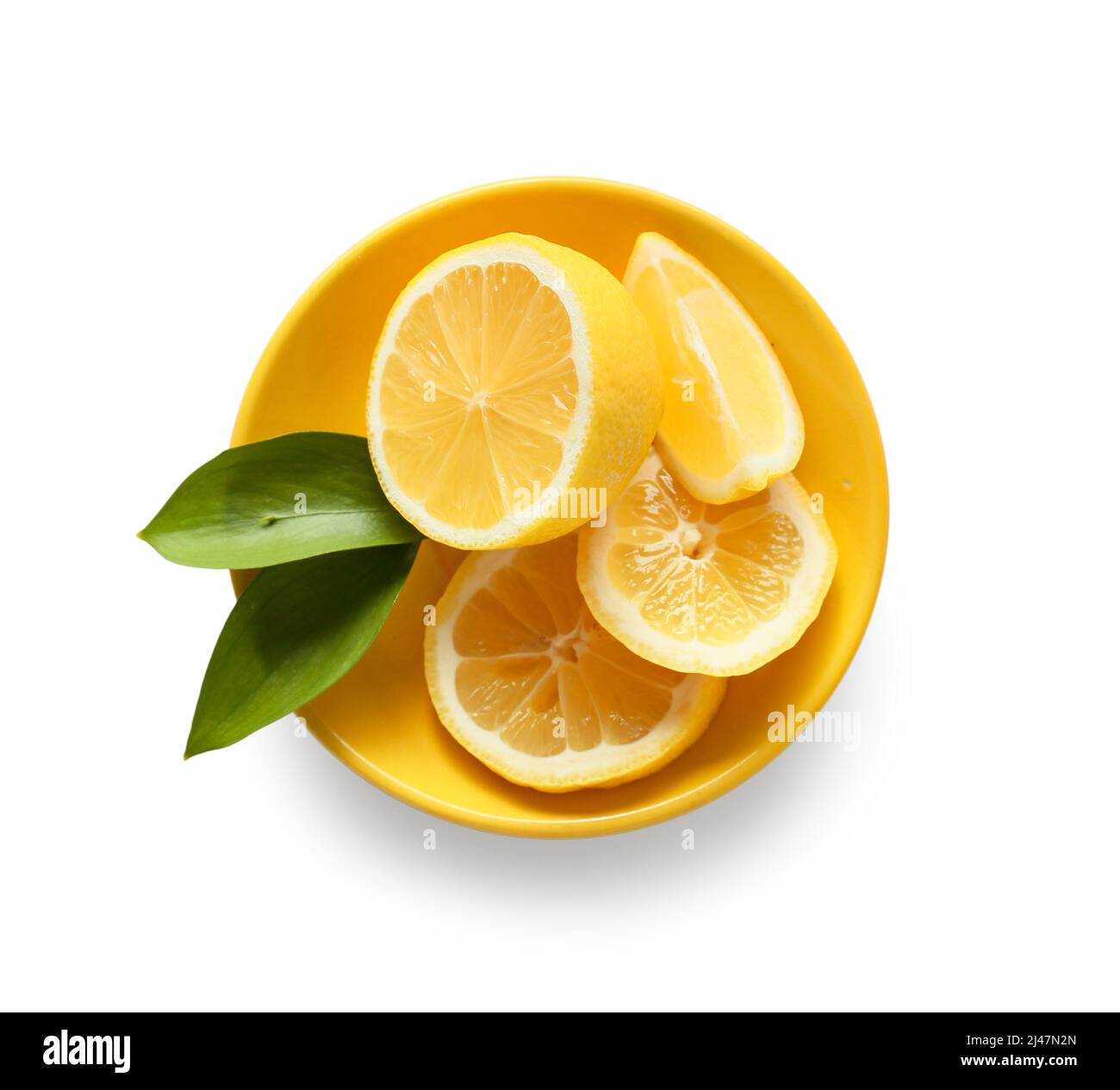 Plate with lemon slices with leaves on white background Stock Photo - Alamy