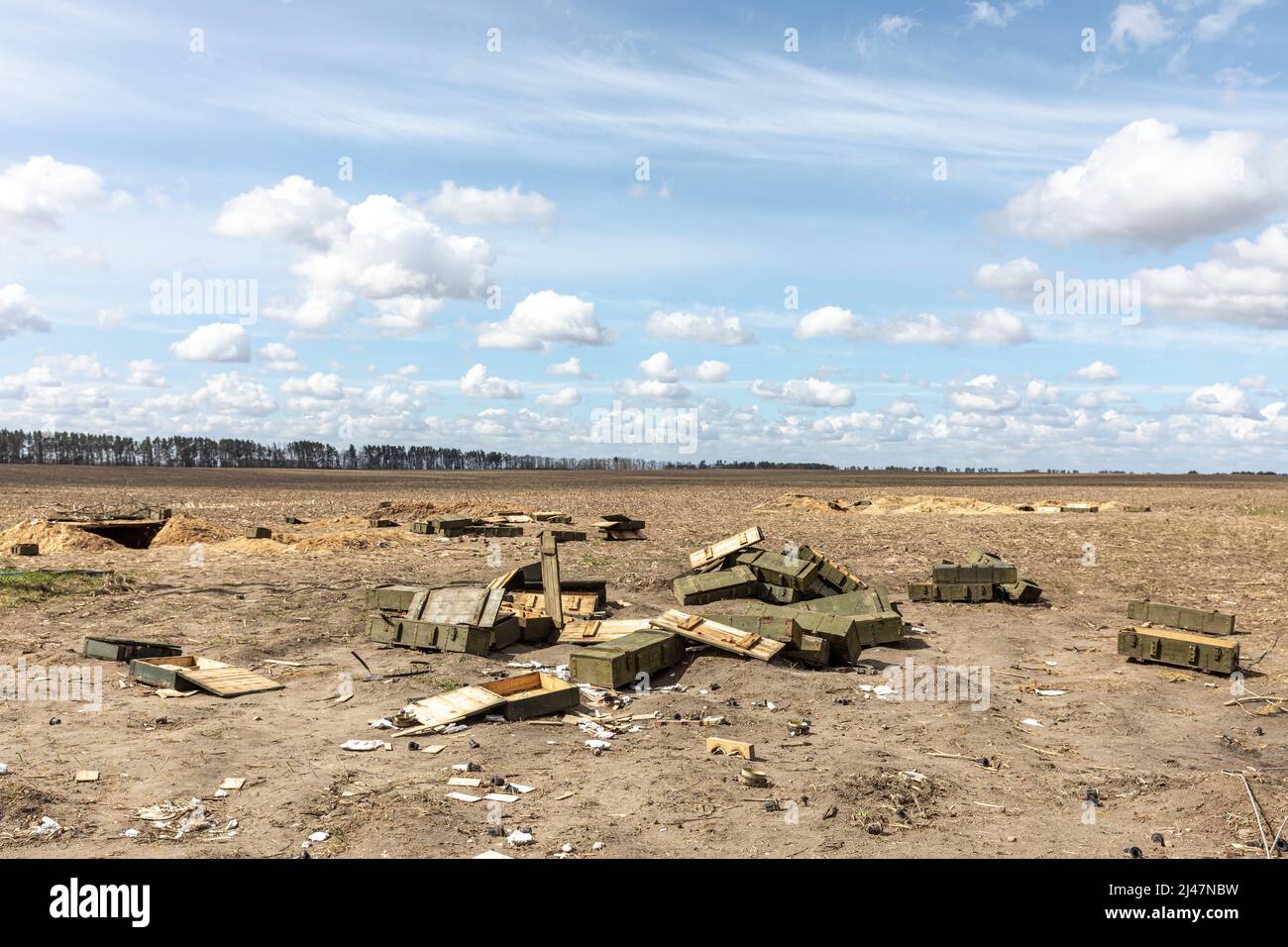 Abandoned military equipment, shells and empty boxes of weapons are ...