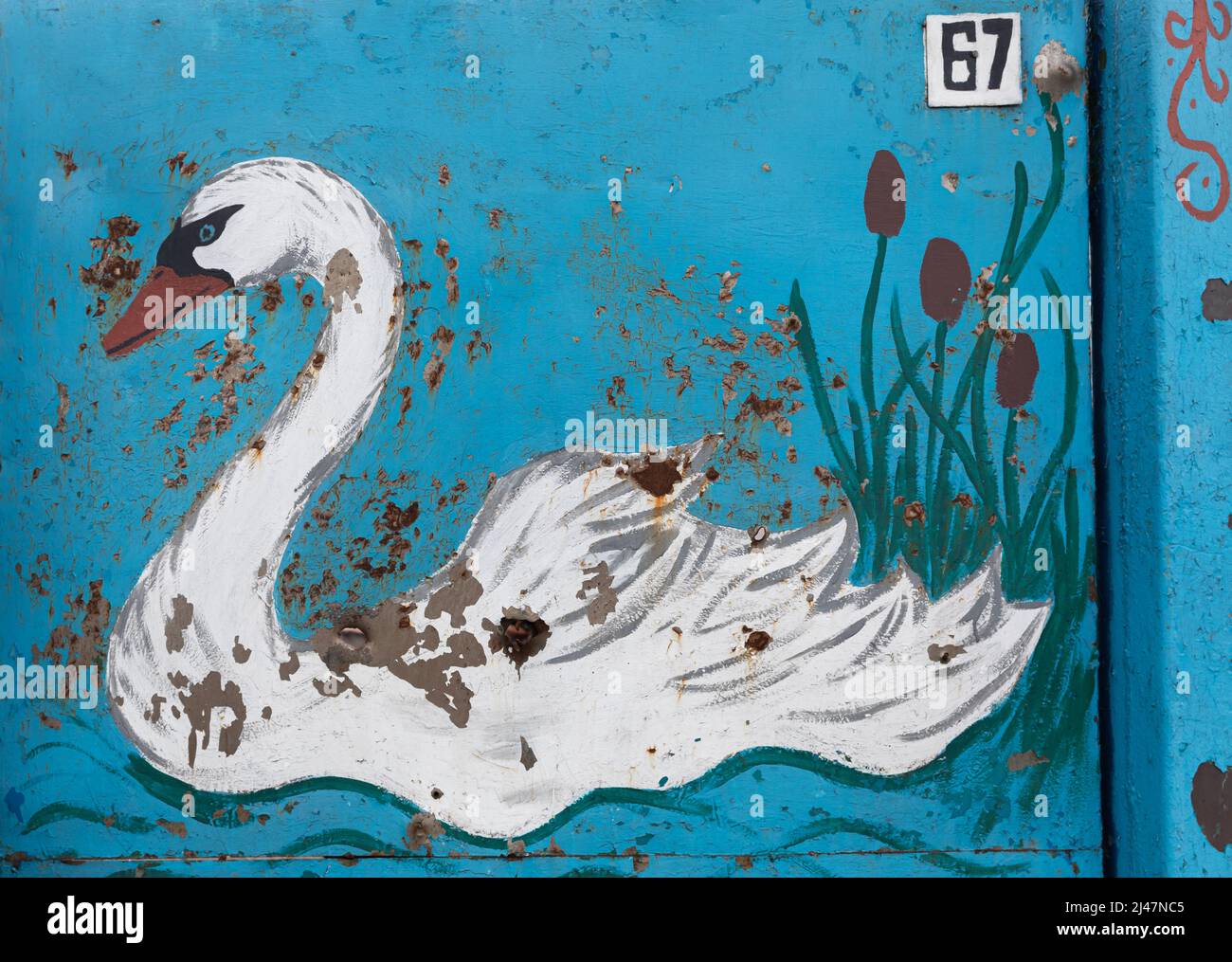 The fence with painted swans is seen damaged from shell fragments ...