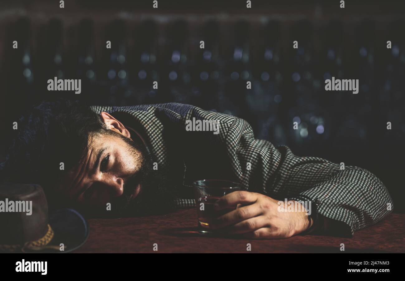 Upset bearded man drinker alcoholic sitting at bar counter with glass drinking whiskey alone ...