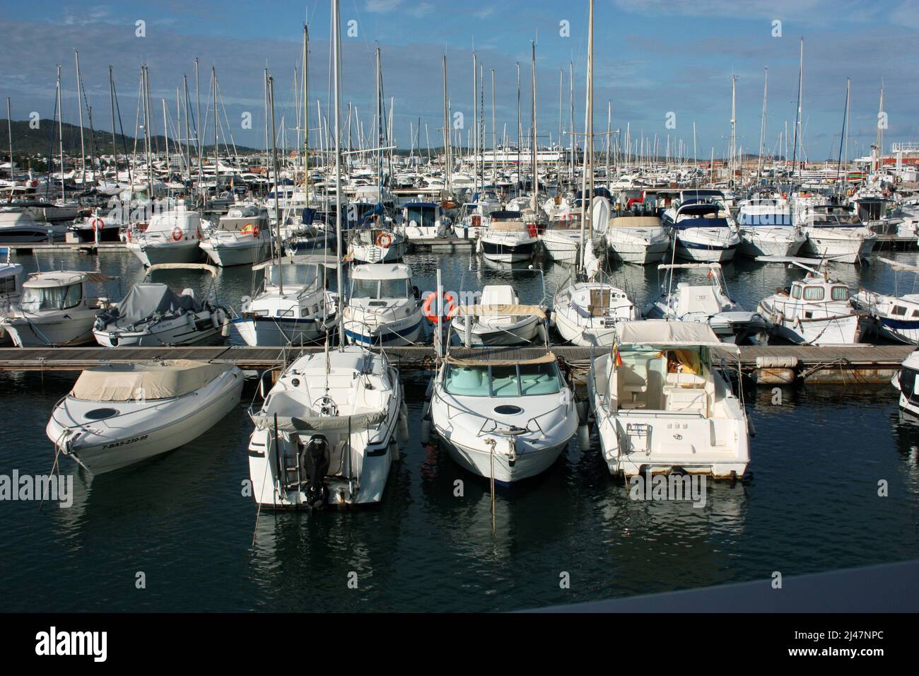 boats moored at the Ibiza tourist pier in the summer in balearic island ...