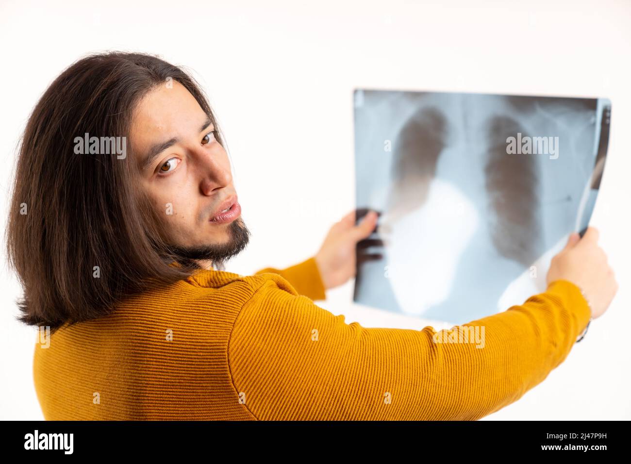 Confused European man looking in disbelief to the camera while holding ...