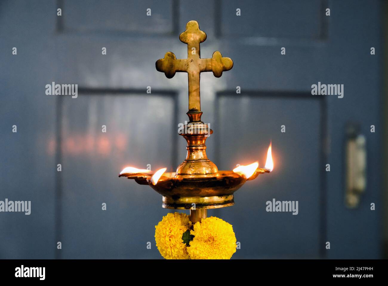 Divine oil lamp with garlands of flowers and cross, Baruipur Catholic ...