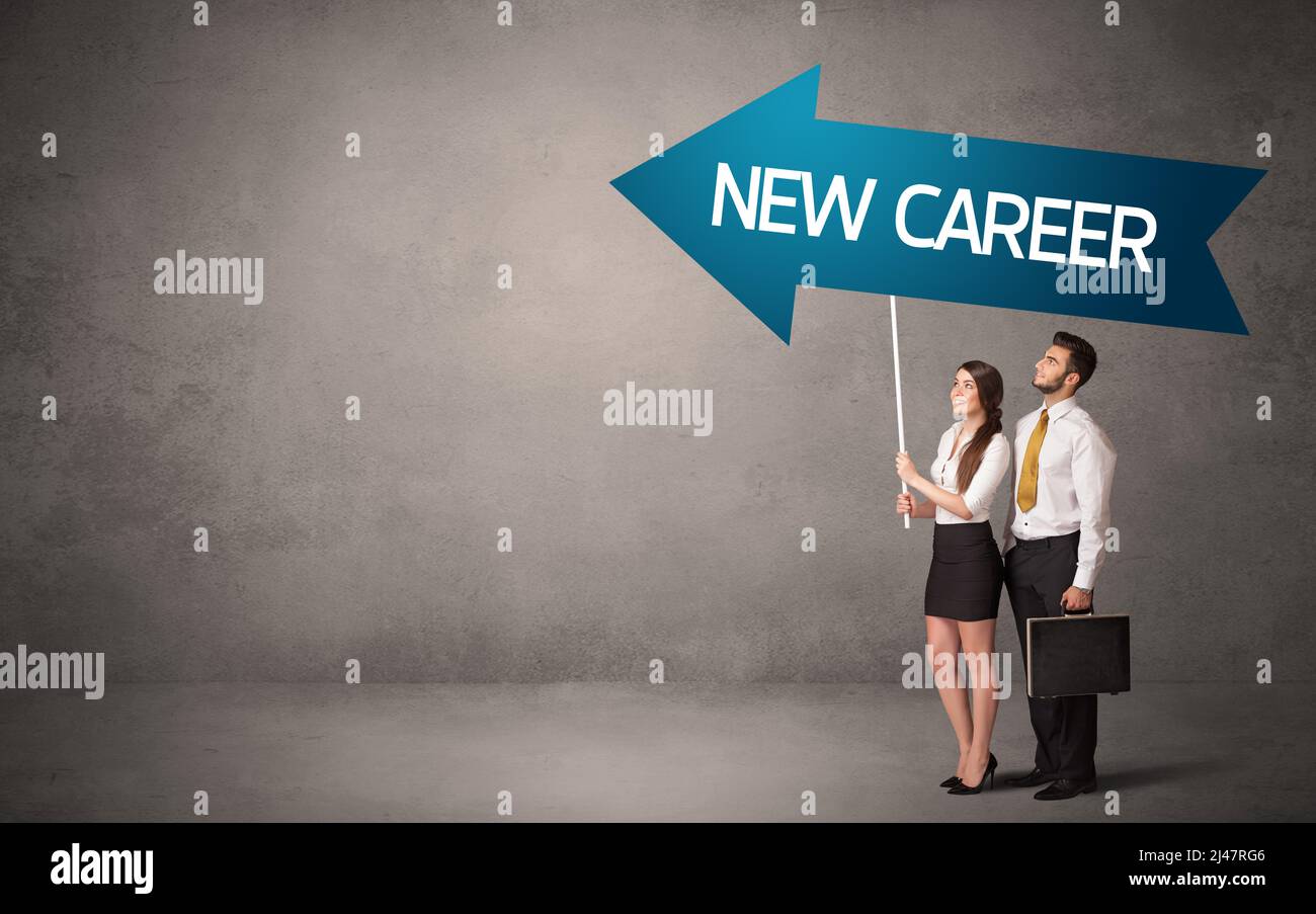 Young business person in casual holding road sign Stock Photo - Alamy