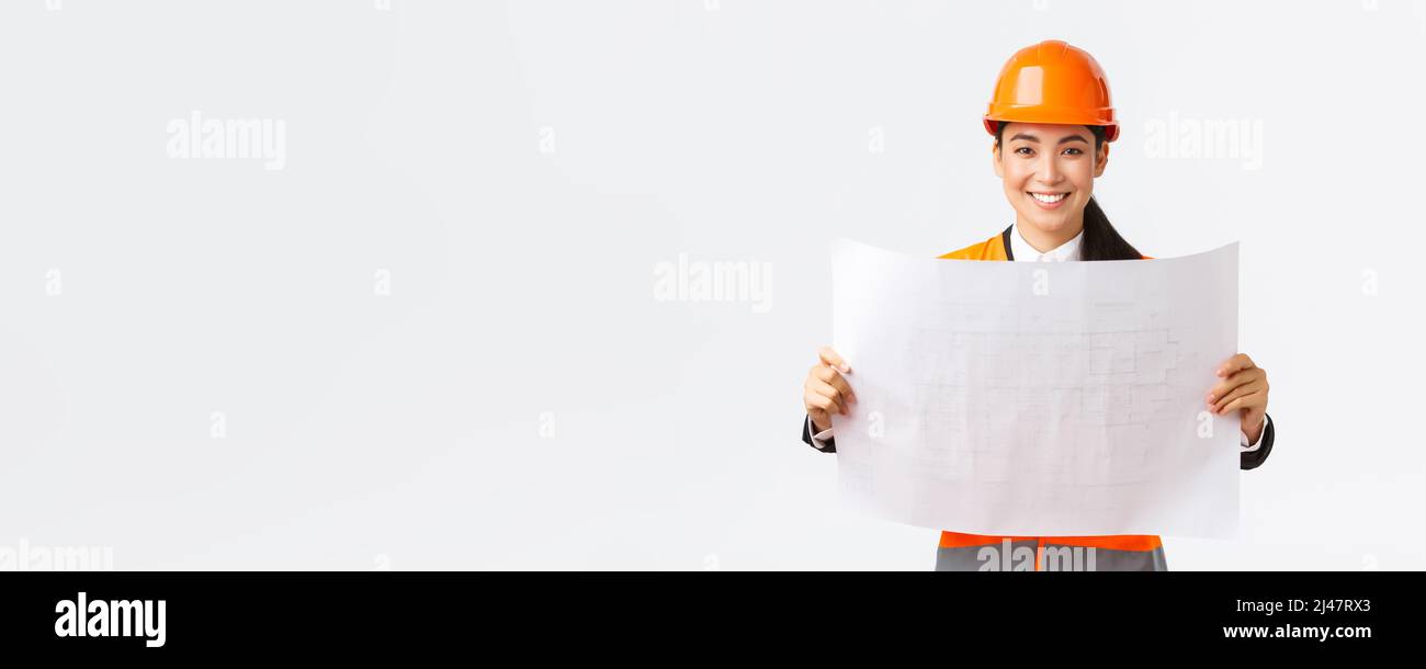 Excited smiling asian female engineer at construction area study ...