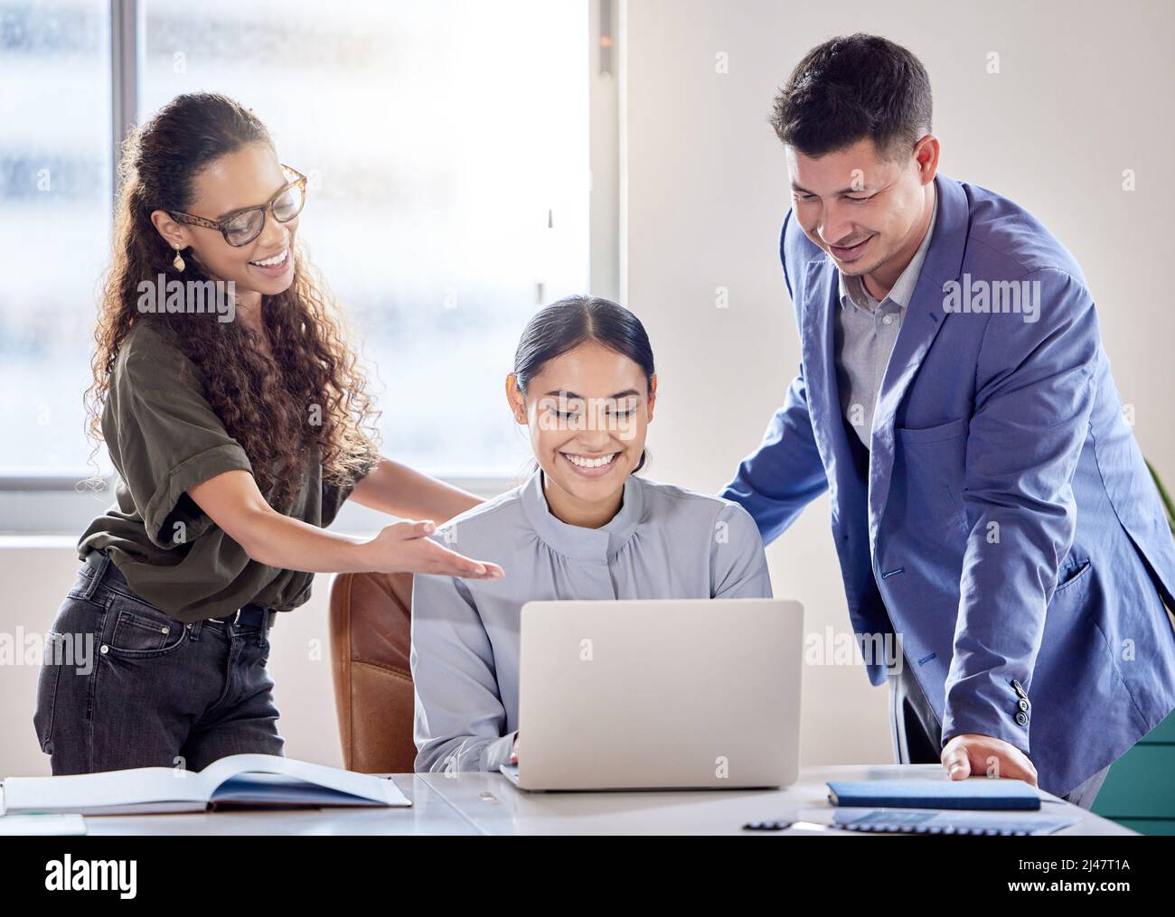 You did a really good job. Shot of a group of colleagues using a laptop ...