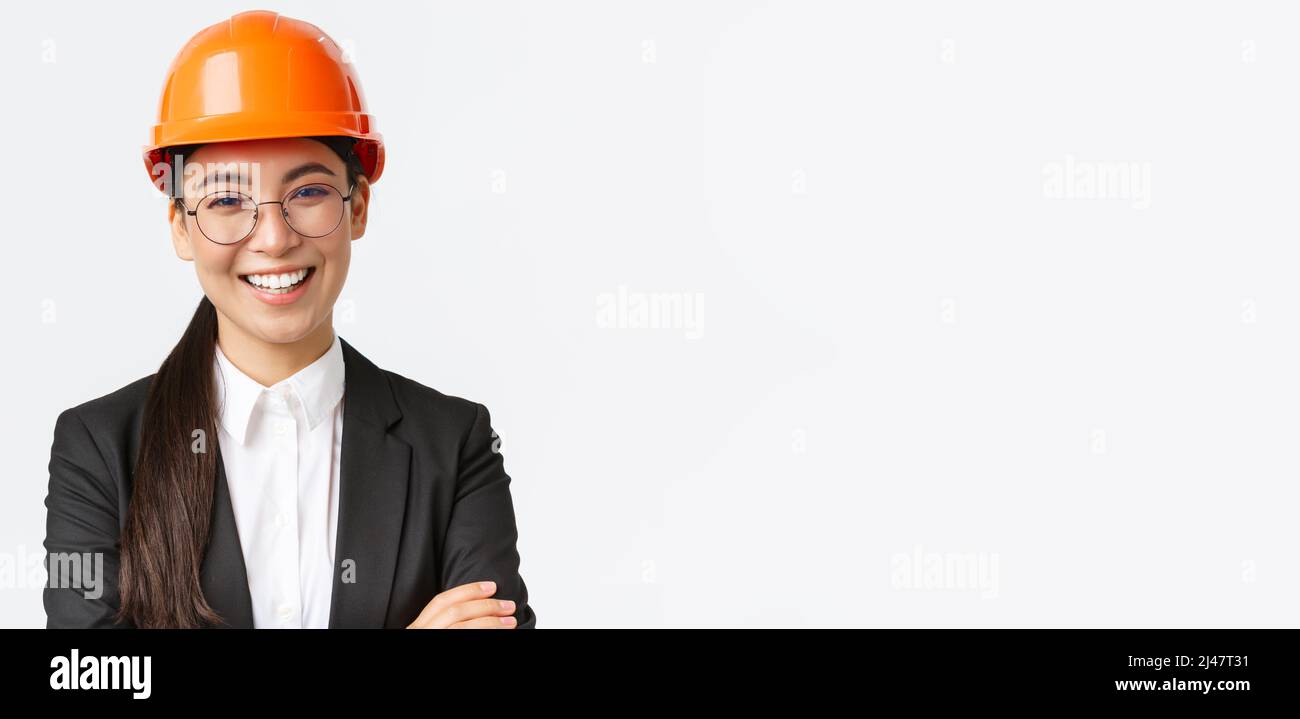 Smiling leader of the team, asian female chief engineer in safety ...