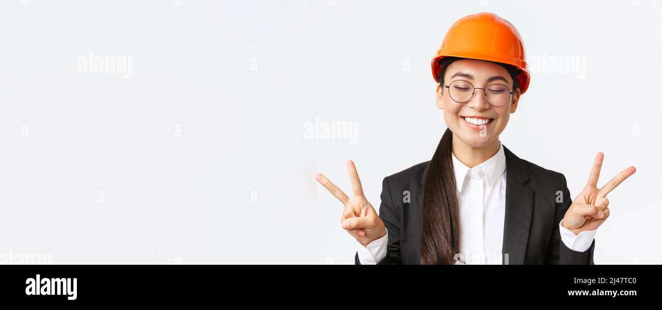 Close-up of cheerful successful female asian engineer, construction ...