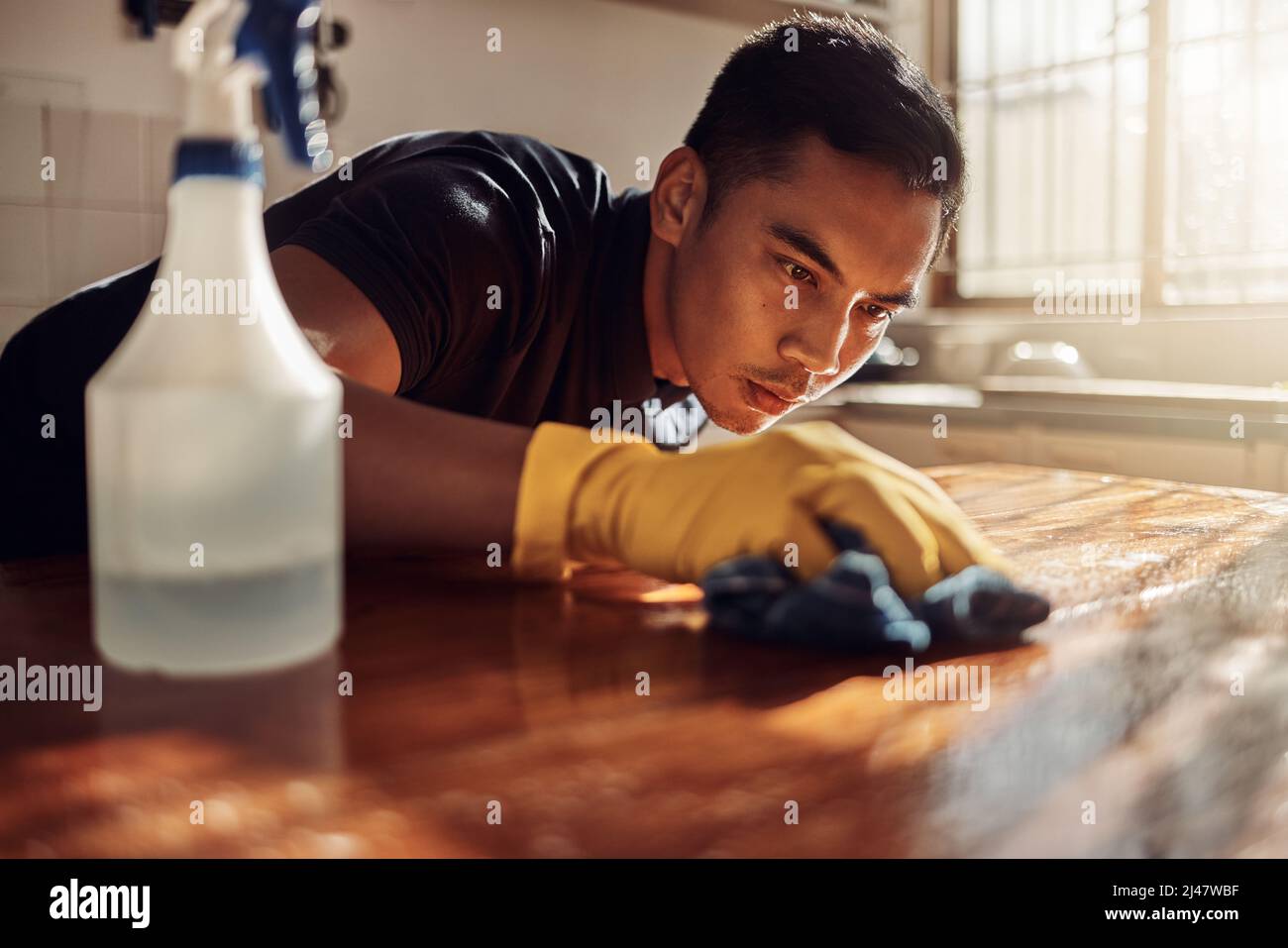 As squeaky clean as a kitchen should be. Shot of a young man ...