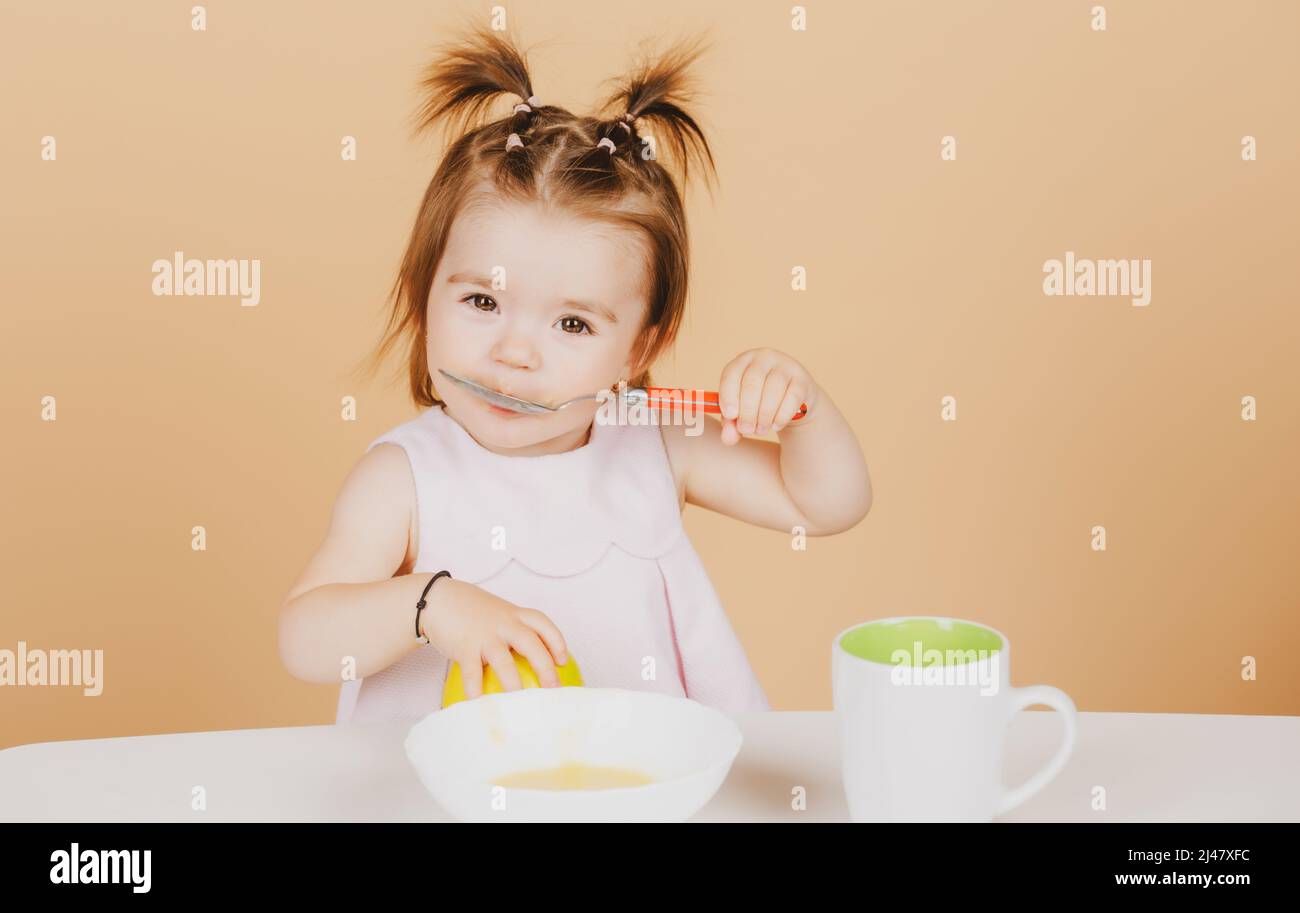 Babies eating, healthy food for a baby. Little baby eating fruit puree ...
