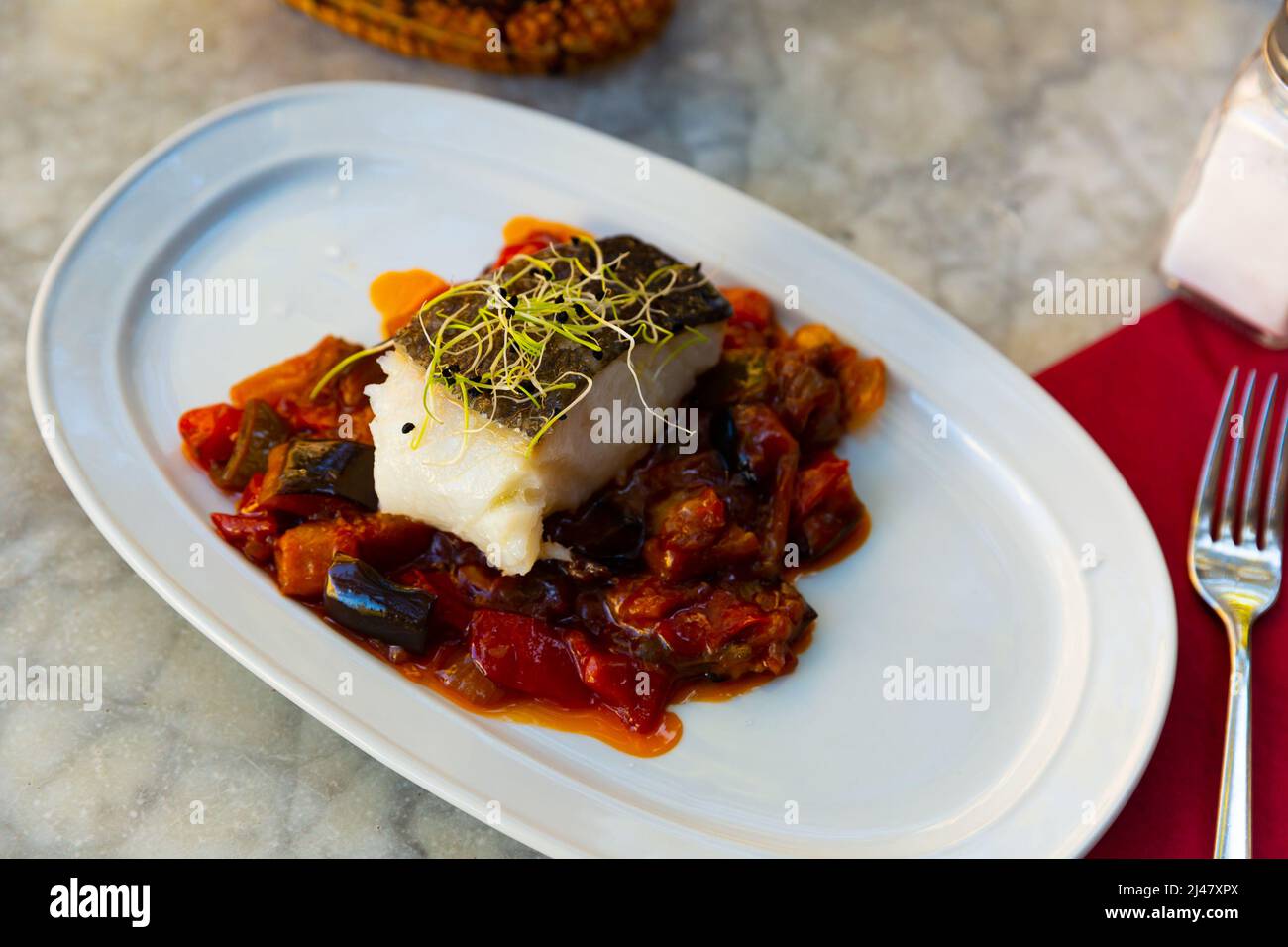 Cod confit with vegetable ratatouille on plate Stock Photo - Alamy