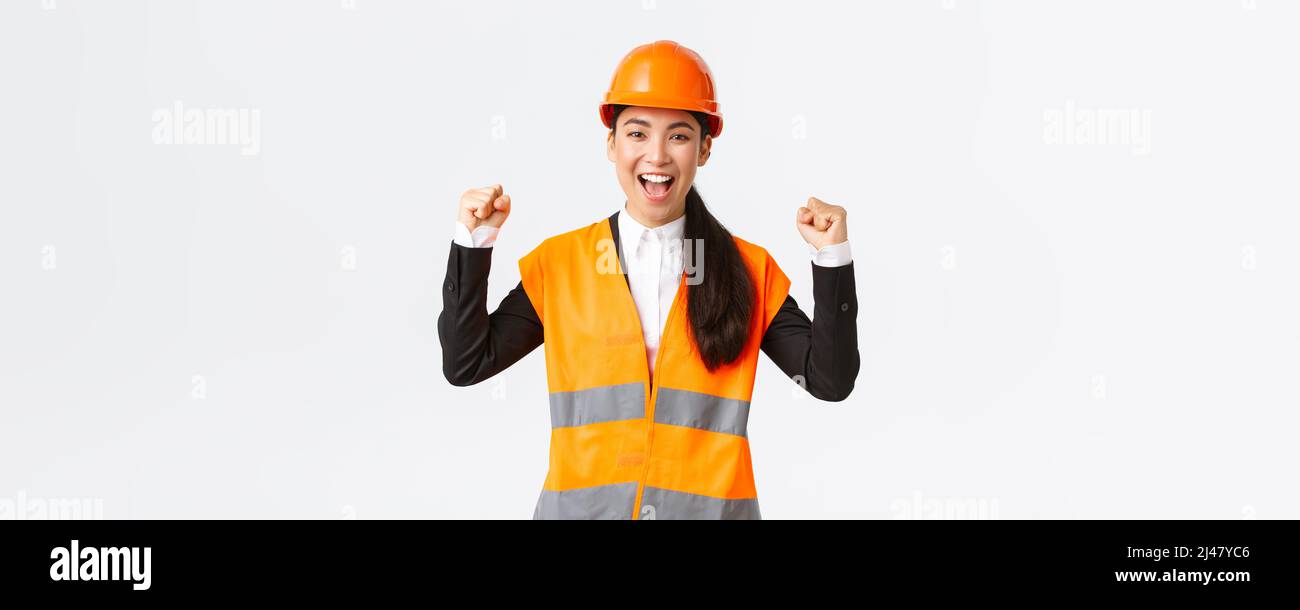 Successful winning female asian engineer fist pump and shout yes ...