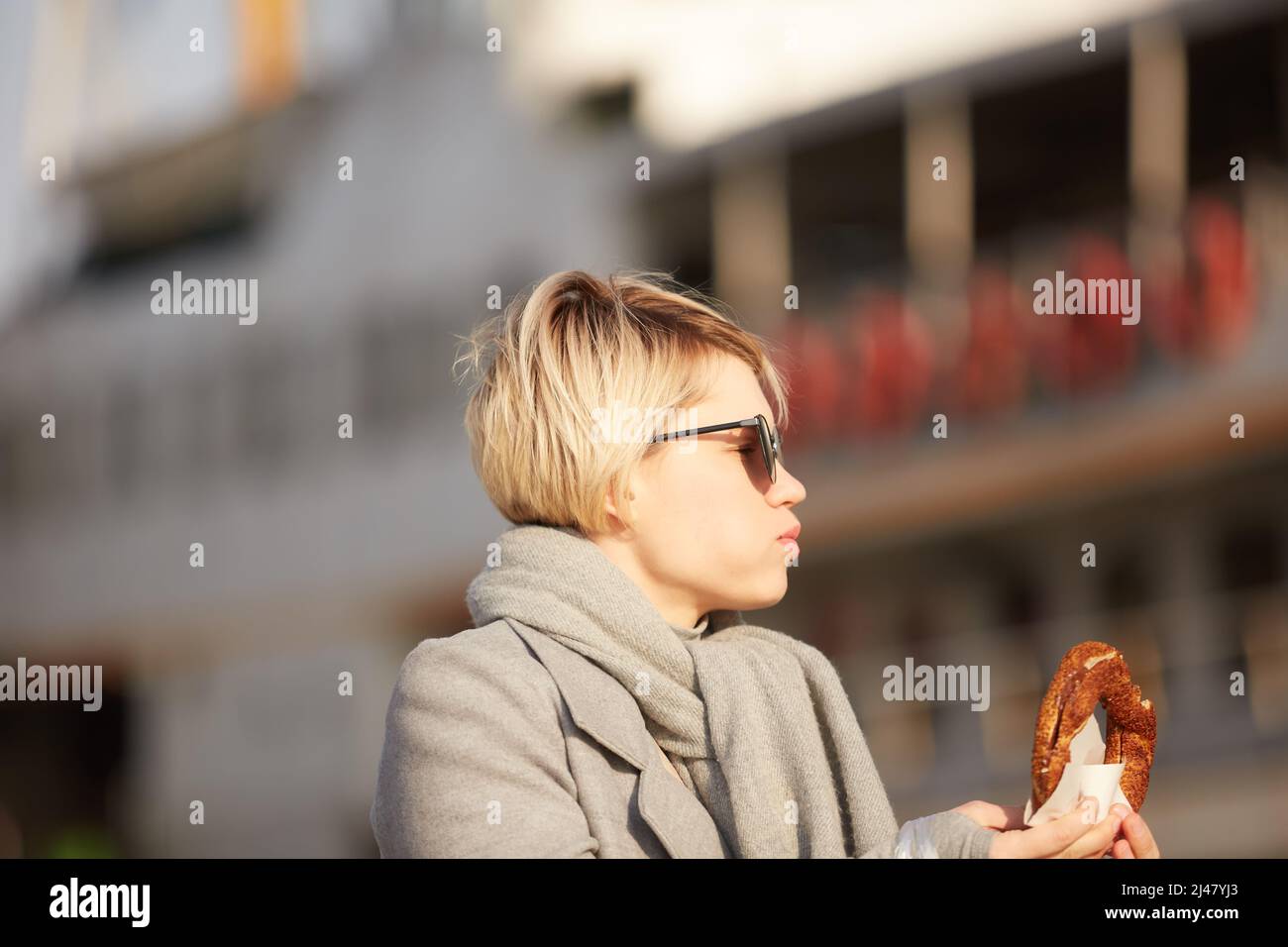 Young woman eating turkish bagel in Istanbul, Turkey. Traditional ...