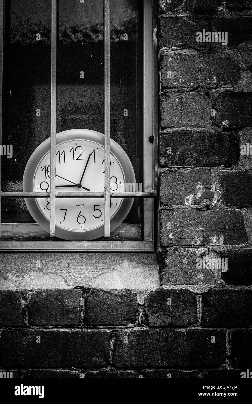 Clock in an old window black and white Stock Photo - Alamy