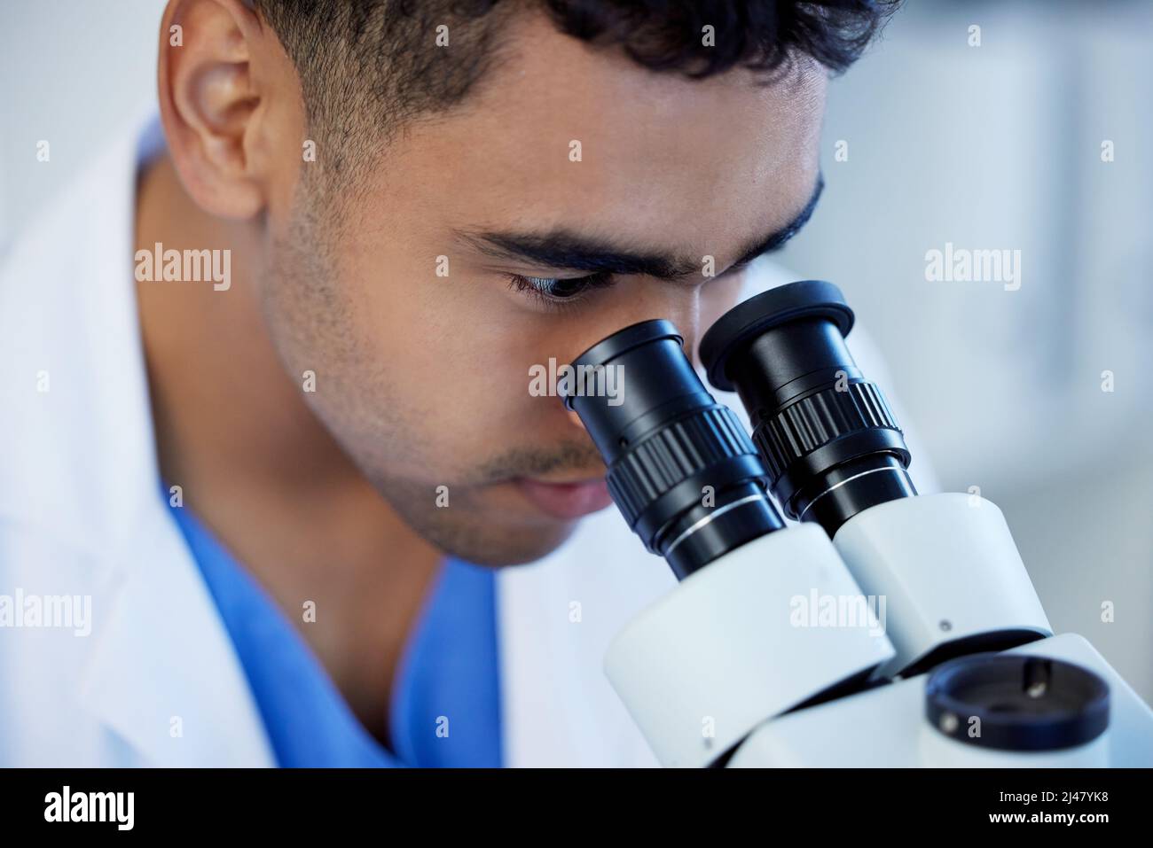 Young man using microscope in hi-res stock photography and images - Alamy