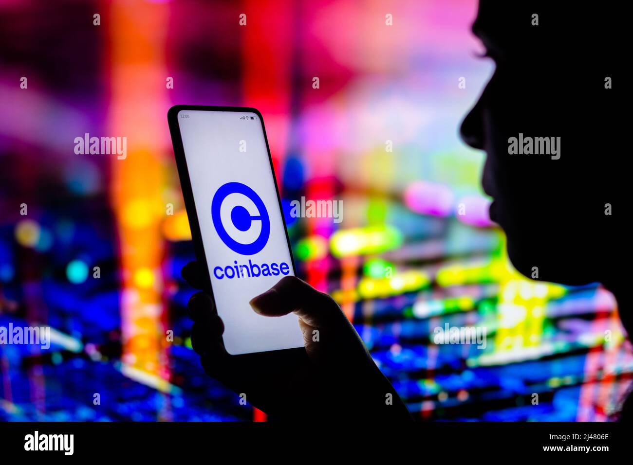 In this photo illustration, a woman holds a smartphone with the ...