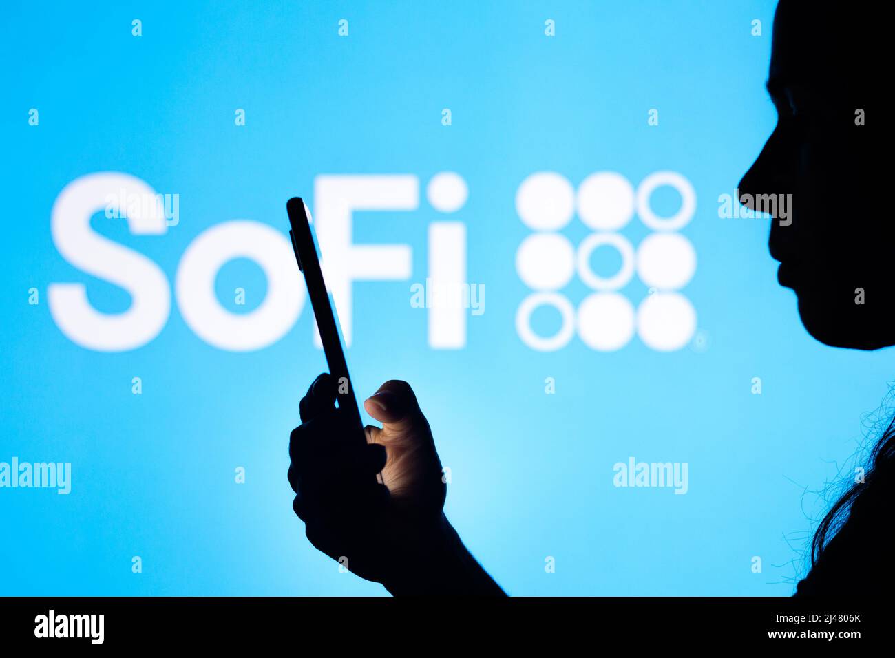 In this photo illustration, a woman's silhouette holds a smartphone ...