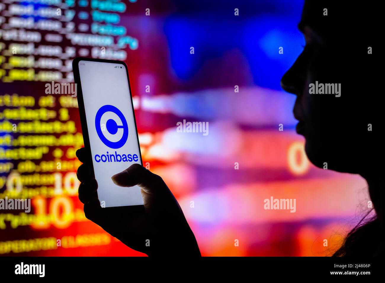 In this photo illustration, a woman holds a smartphone with the ...