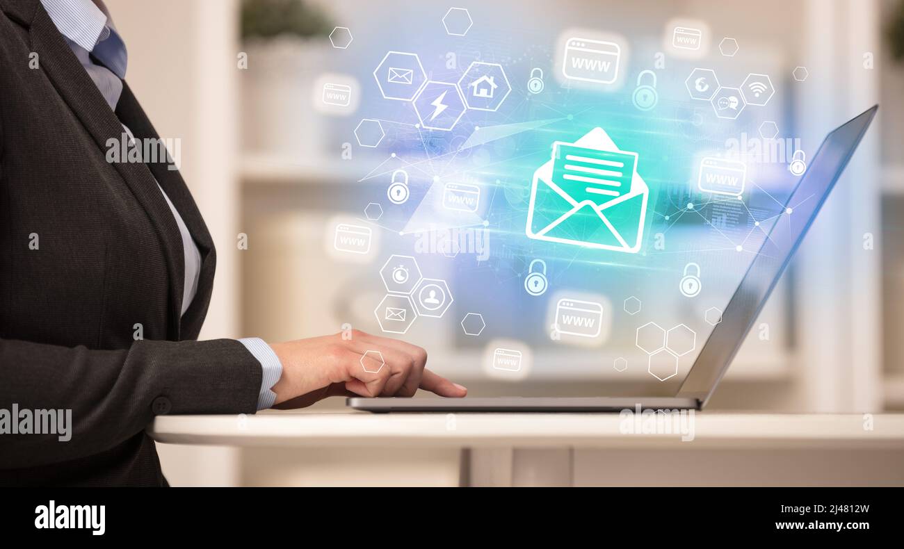 Hands working on laptop with digital icons Stock Photo - Alamy