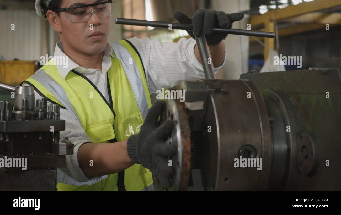 Asian professional mechanical operation man wearing uniform hardhat and ...