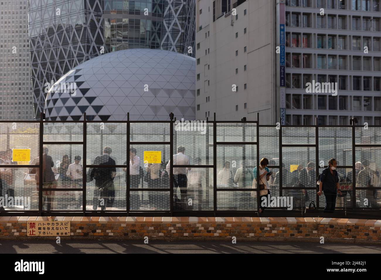 Smokers use a designated smoking area in front of Shinjuku Station on ...