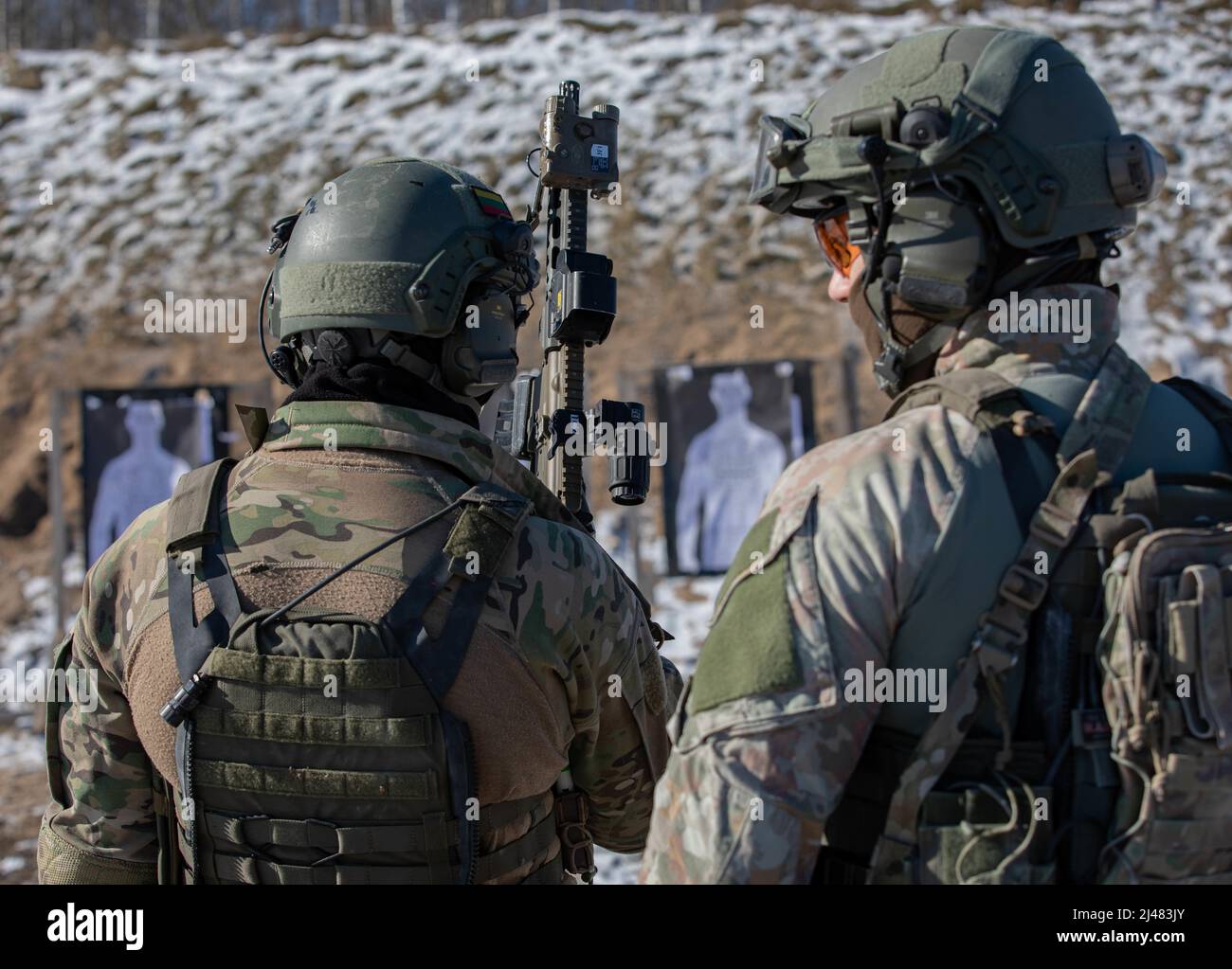 A Lithuanian Special Forces member receives feedback from his ...
