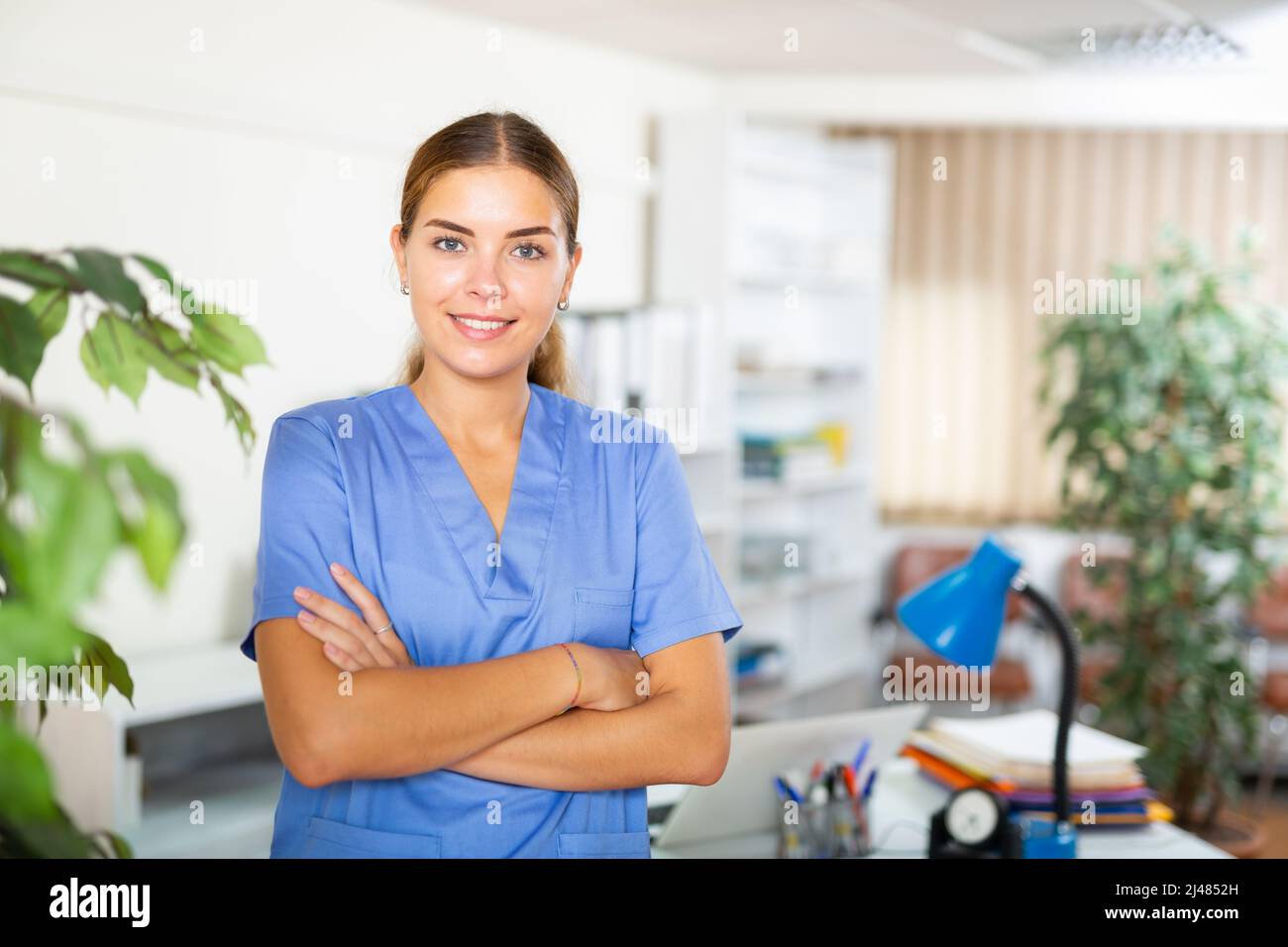 Female doctor standing in hall of clinic Stock Photo - Alamy