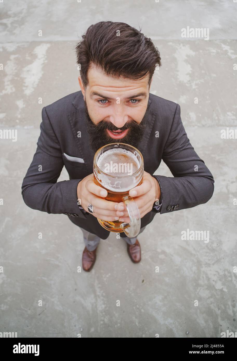 Crazy funny elegant man drinking beer. Happy brewer holding glass with ...