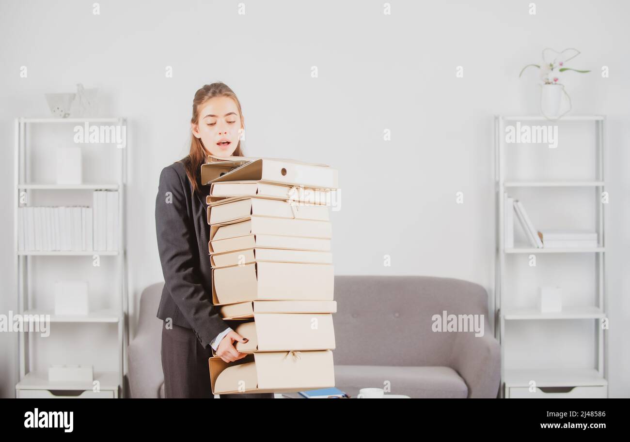 Overworked in the office. Female worker exhausted with too much paper ...