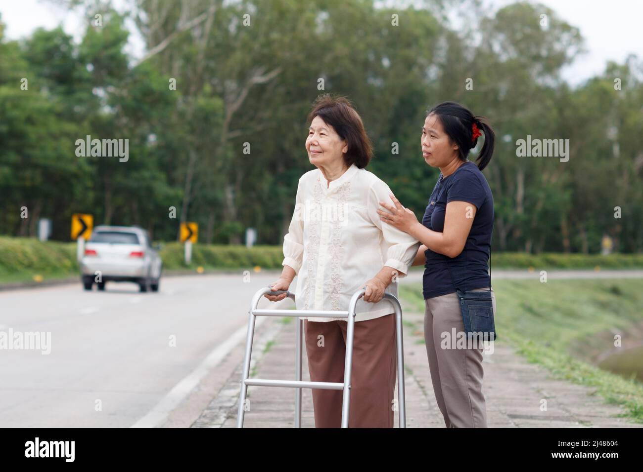 senior woman using a walker cross street Stock Photo - Alamy