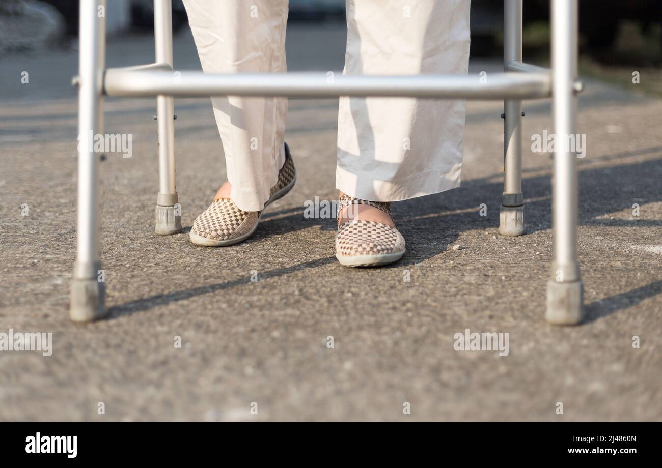 senior woman using a walker cross street Stock Photo - Alamy