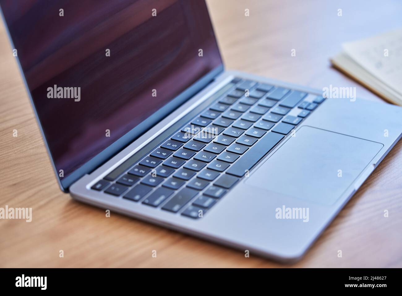Self-educate and innovate. Shot of a laptop on a desk in an empty ...