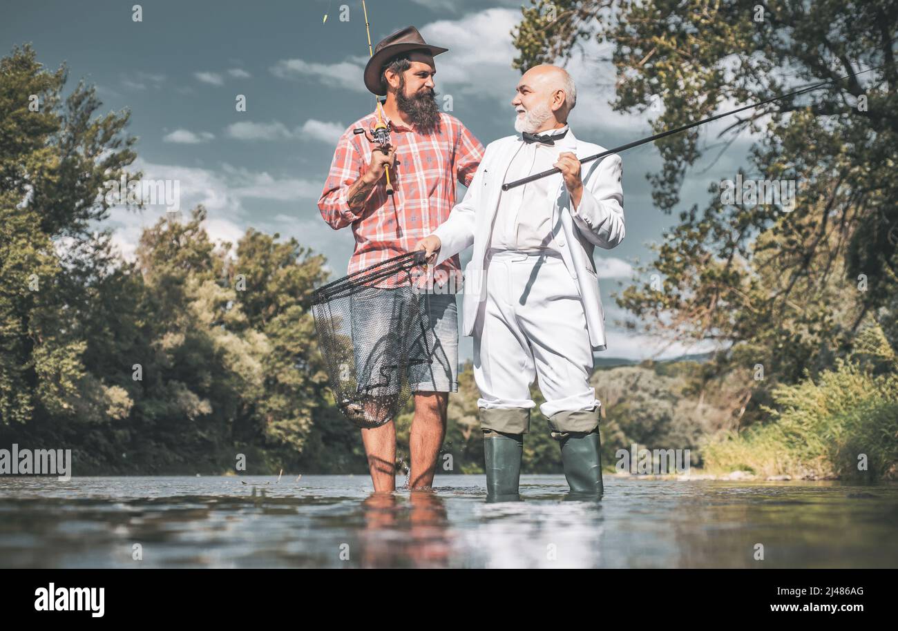 Happy family concept - father and son together. Fly angler on the river ...