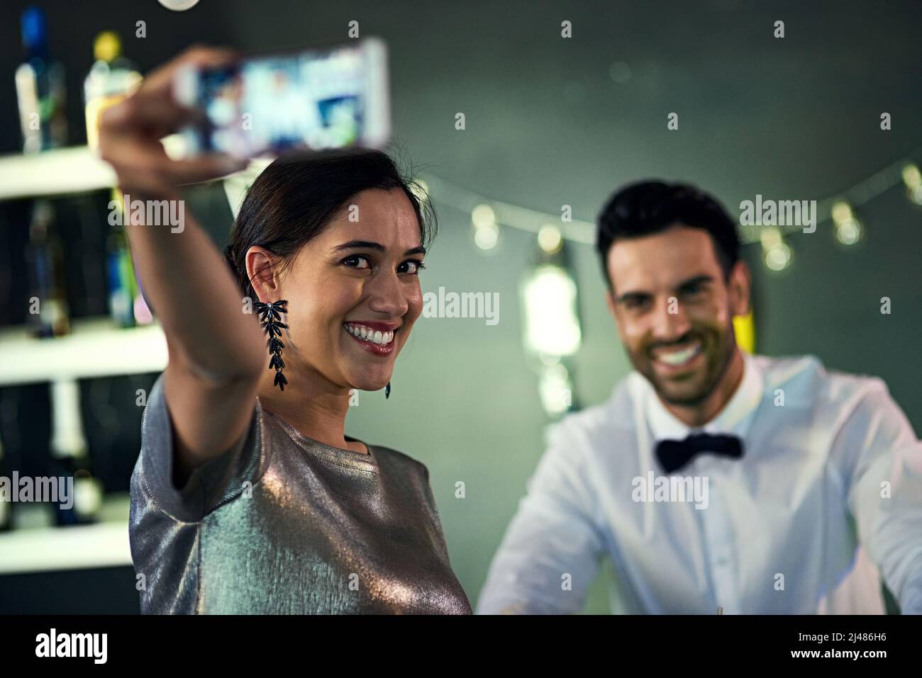 I want to remember this night. Shot of a young woman taking a selfie ...