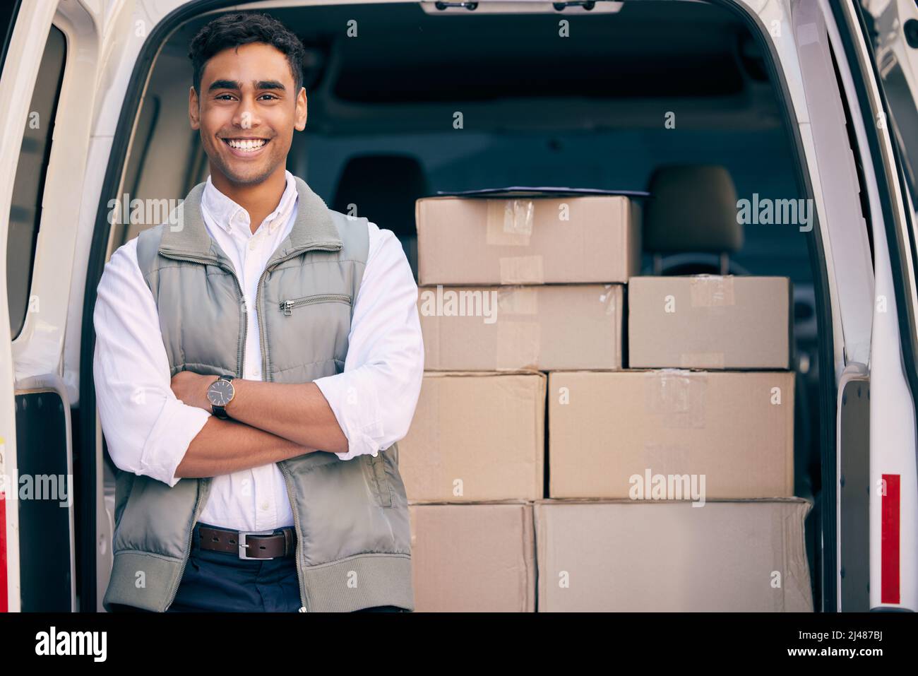 I have quite a few deliveries today. Shot of a delivery man standing ...