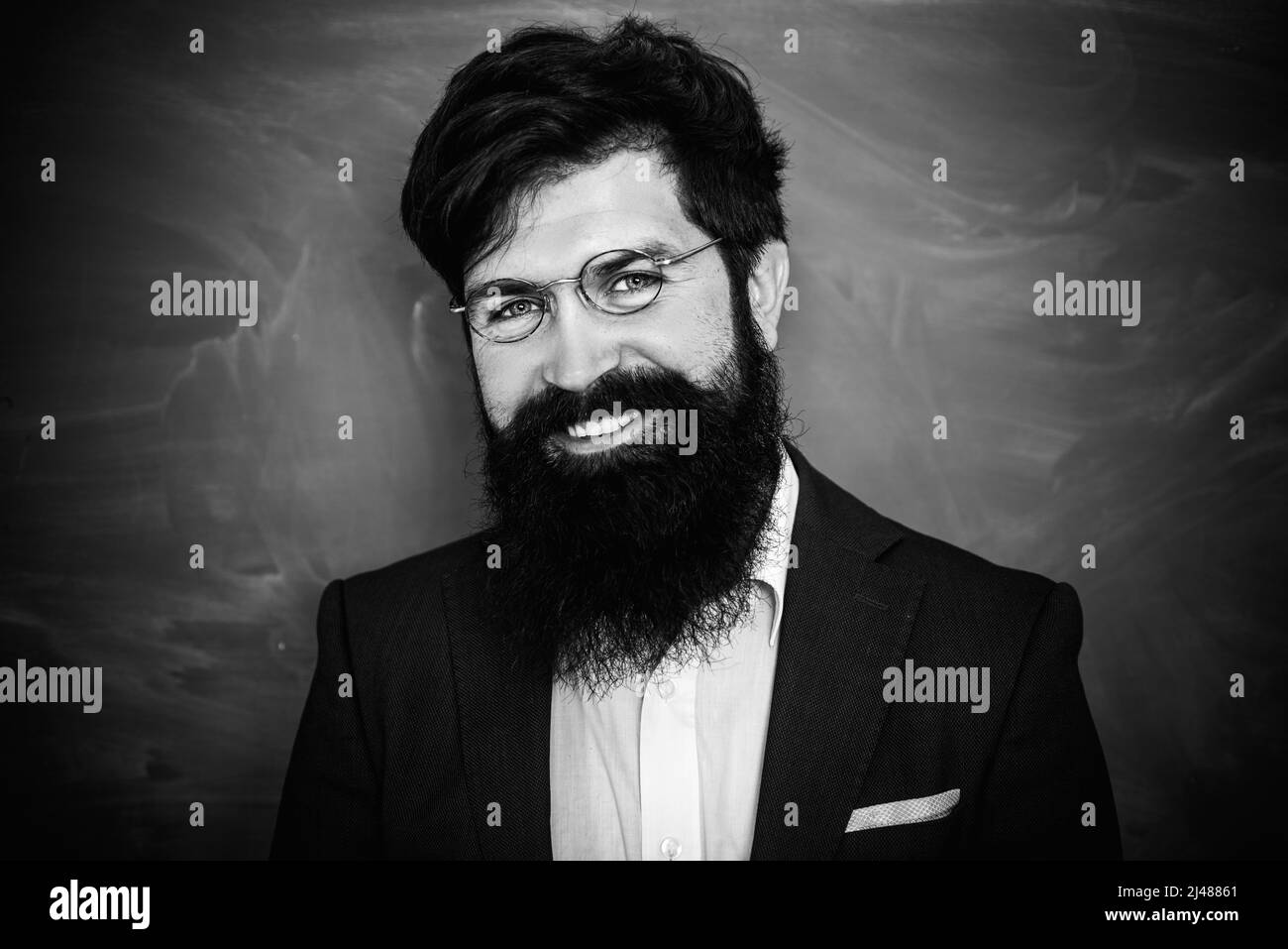 Teachers challenges and inspires. Bearded professor at school lesson at ...