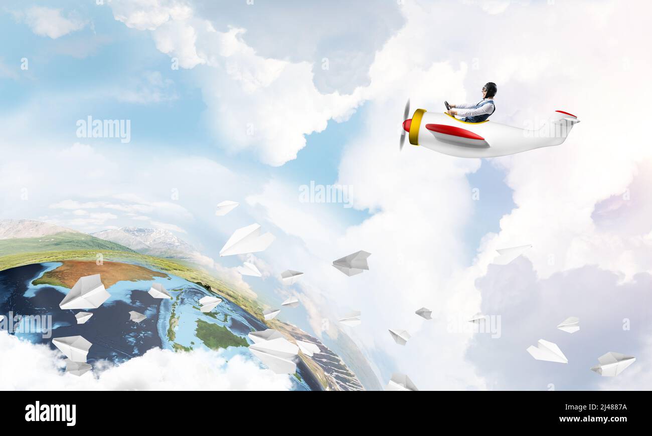 Pilot in leather helmet driving propeller plane Stock Photo - Alamy