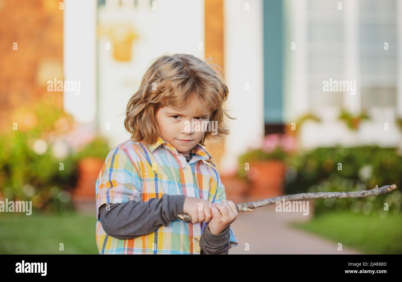 Child negative aggression. Kids emotion concept. Angry boy with stick ...