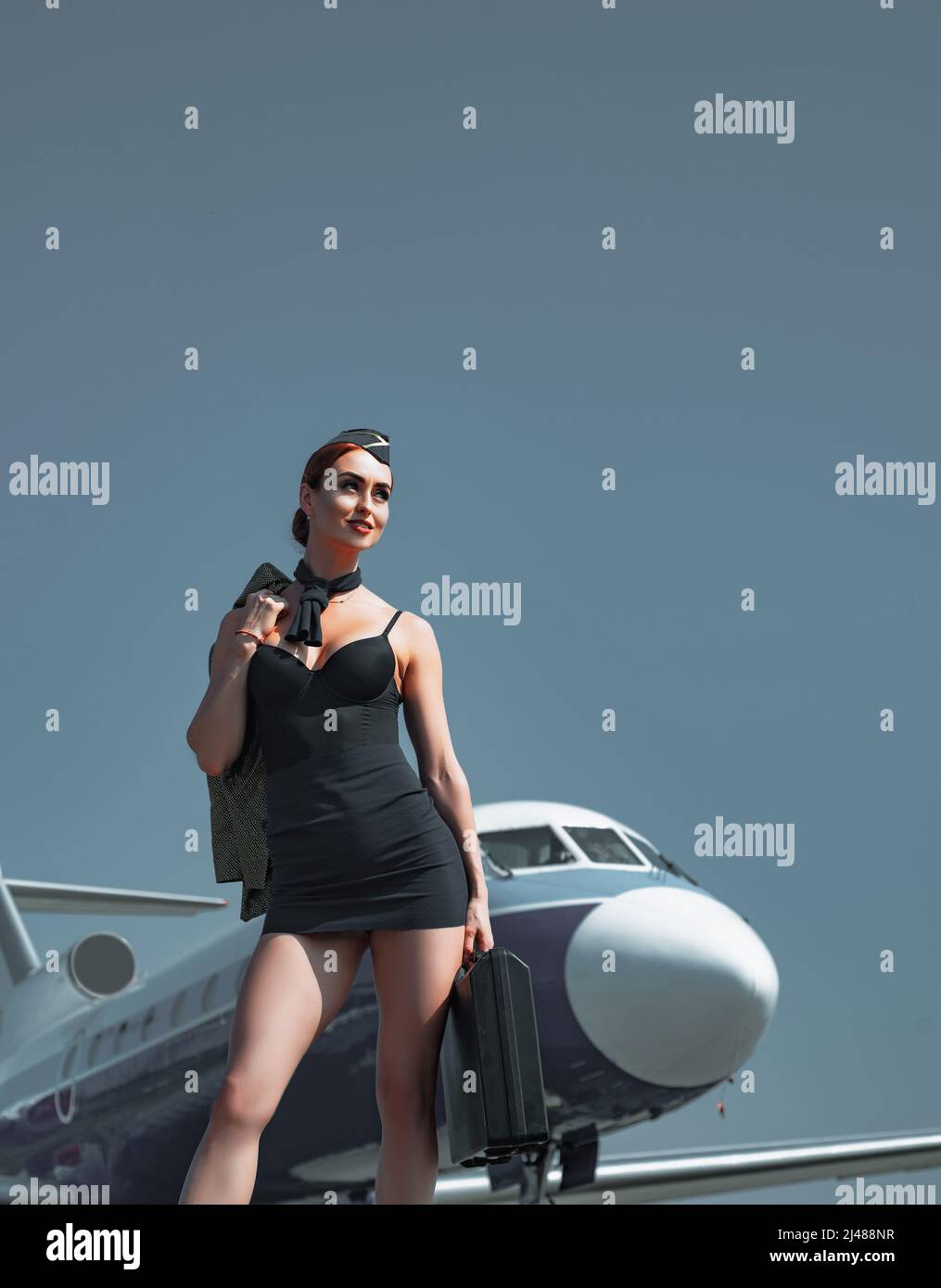 Charming stewardess dressed in blue uniform. Aviation and ...