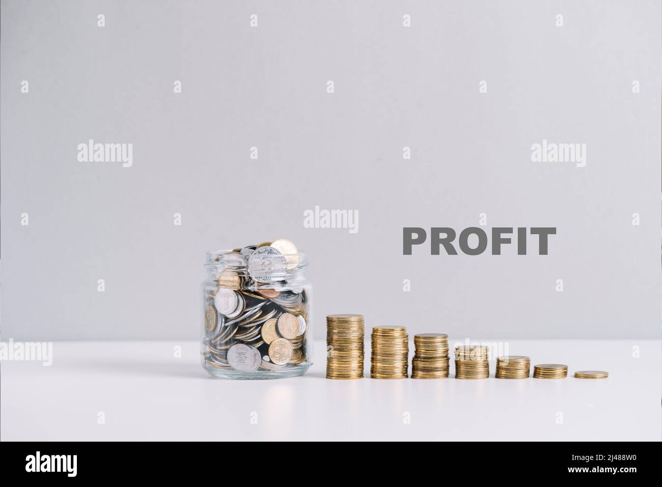 Profit with jar of coins Stock Photo - Alamy