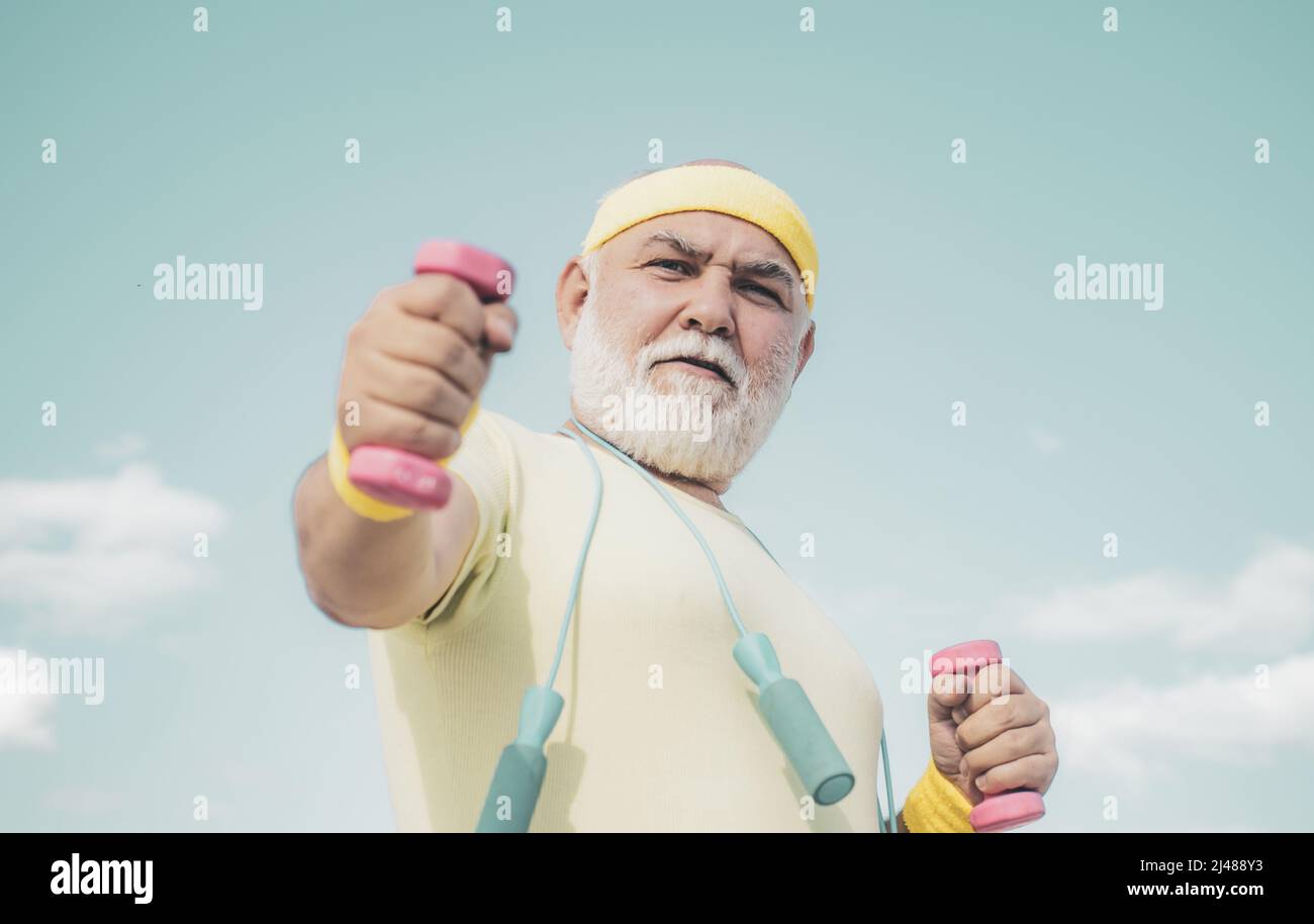 Old mature man exercising with dumbbell. Healthy lifestyle concept ...