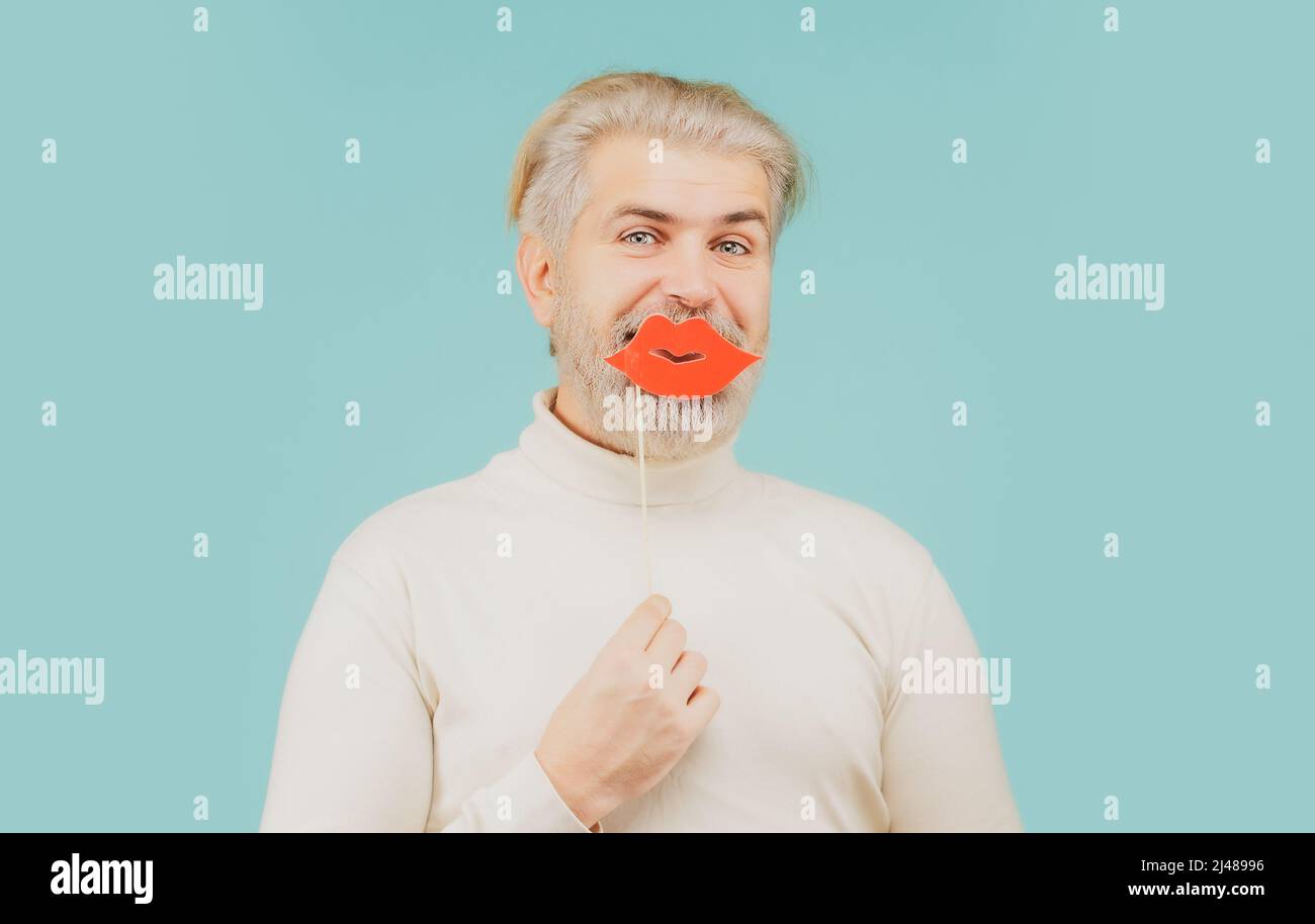 Photo booth concept. Man holding party lips. Bearded man with ...