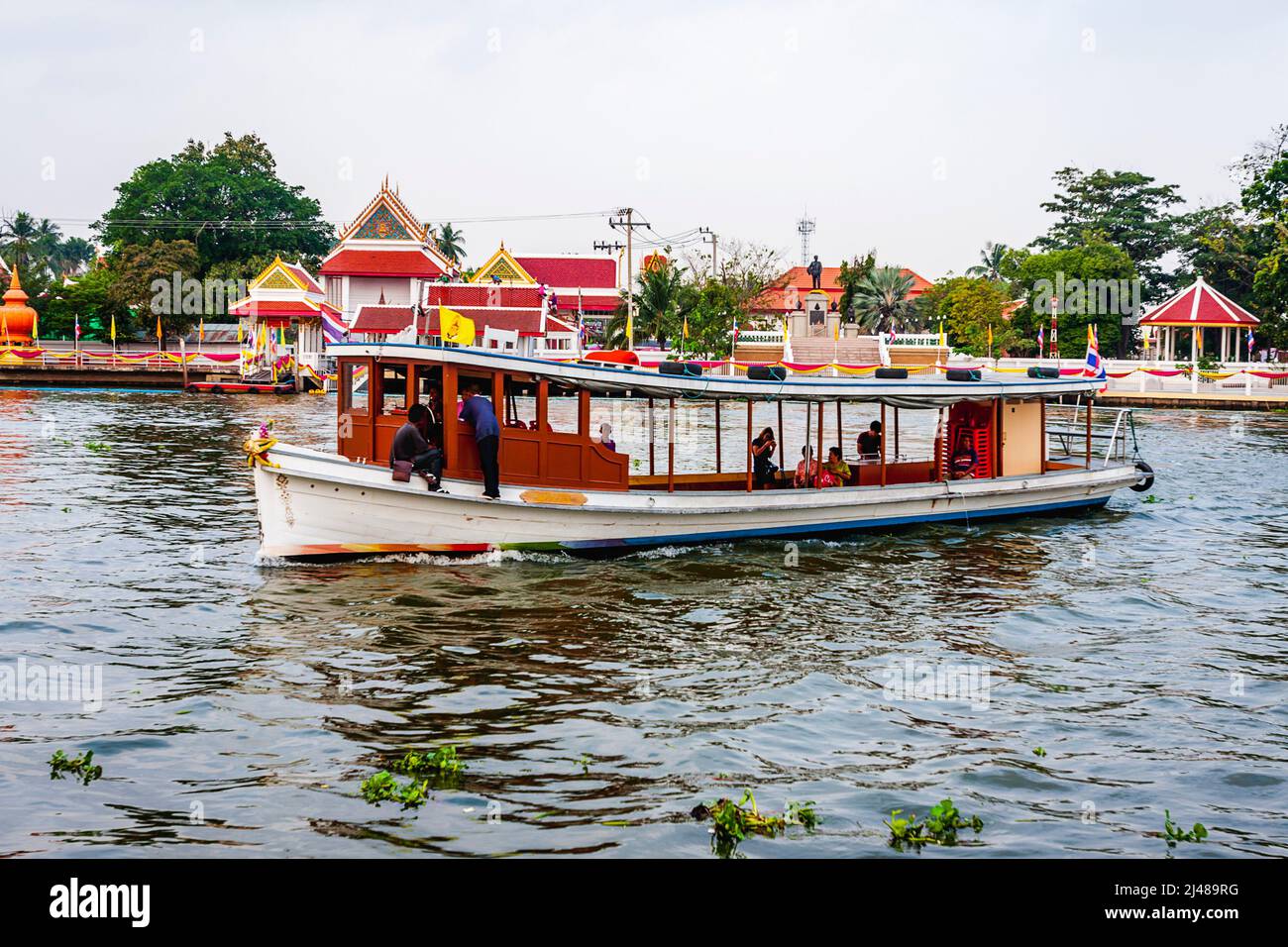 A small passenger boat transports people back and forth across the ...